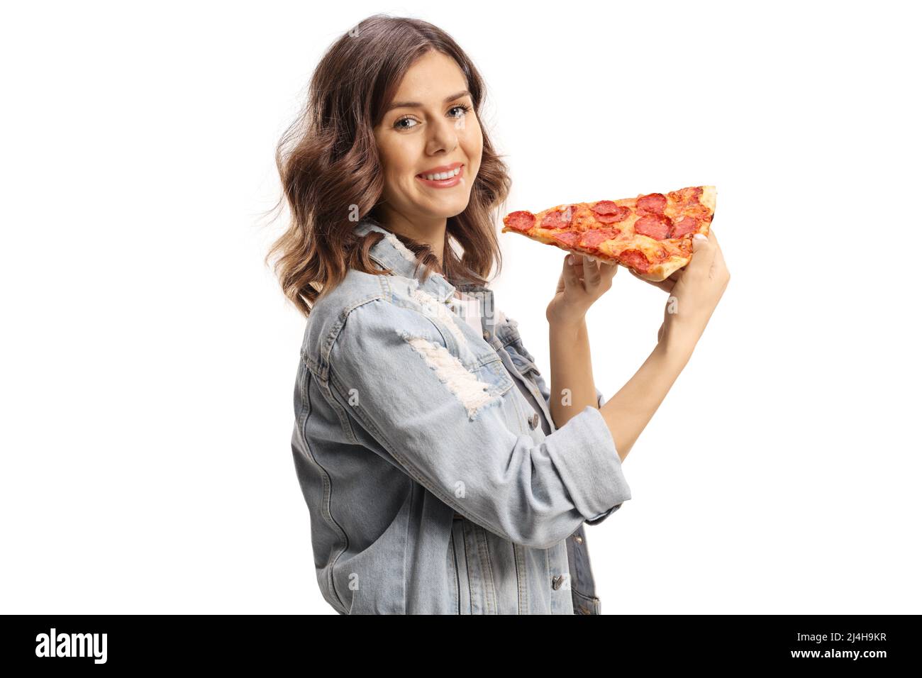 Young female holding a slice of pepperoni pizza and smiling isolated on ...