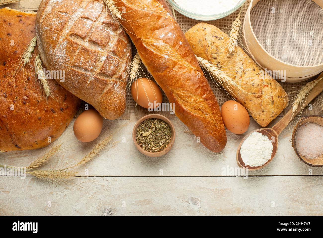 Bread of different varieties on a wood background with copy space ...