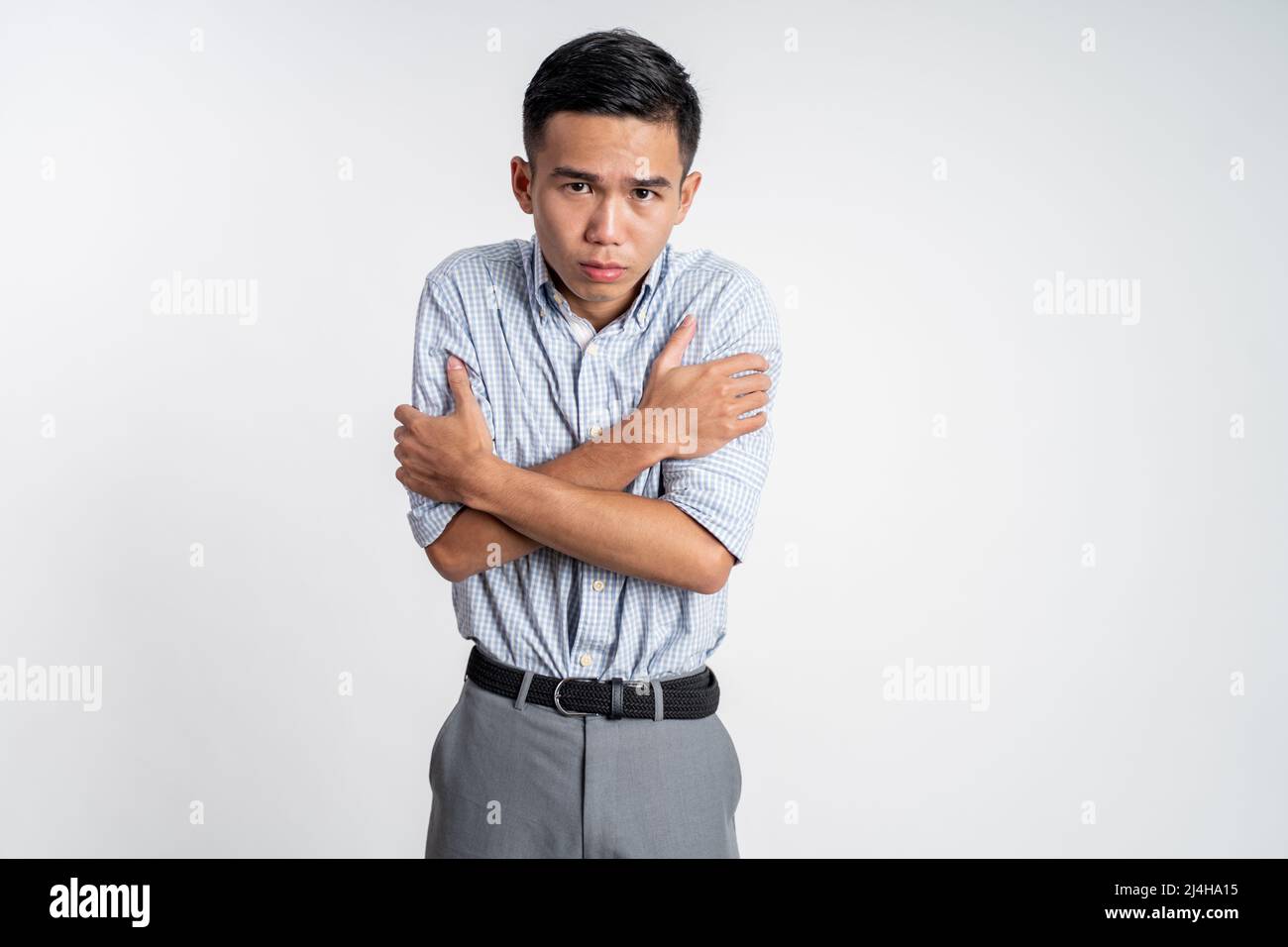 man shivering while holding his two arms hug himself Stock Photo - Alamy