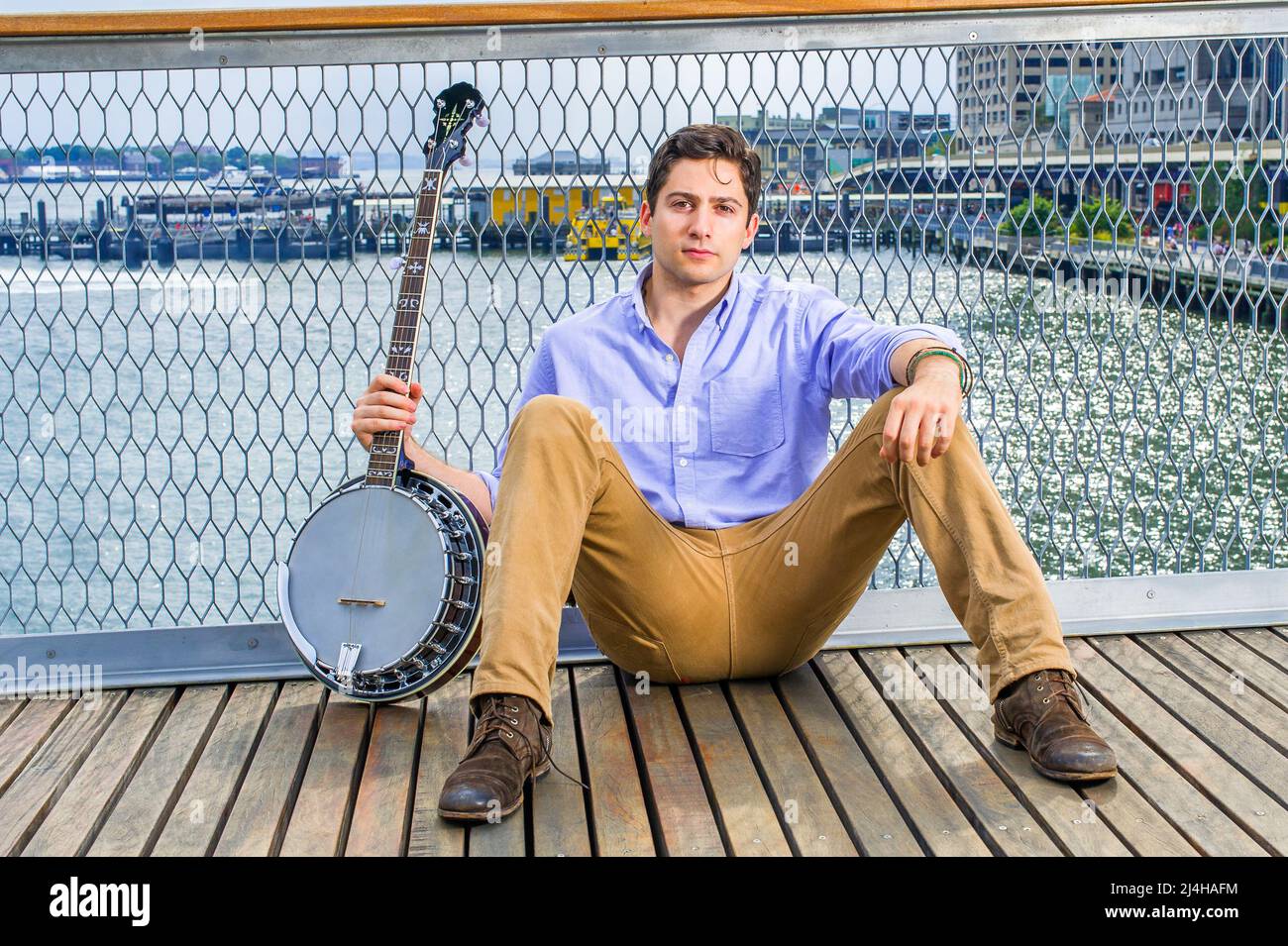 Dressing in a light blue shirt, dark yellow jeans and brown boot shoes ...