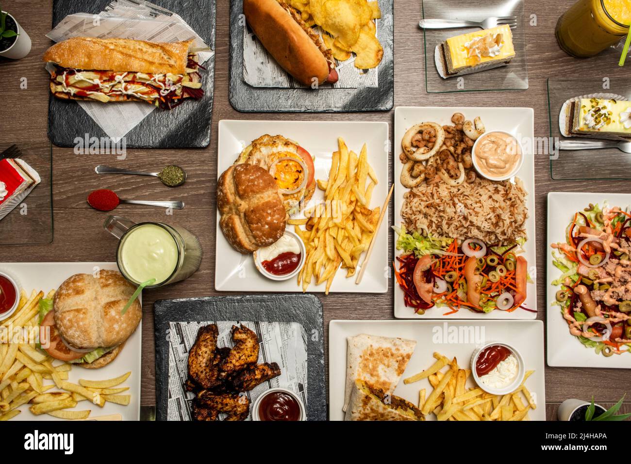 Fast food dishes with basmati rice with squid, hot dogs, assorted ...