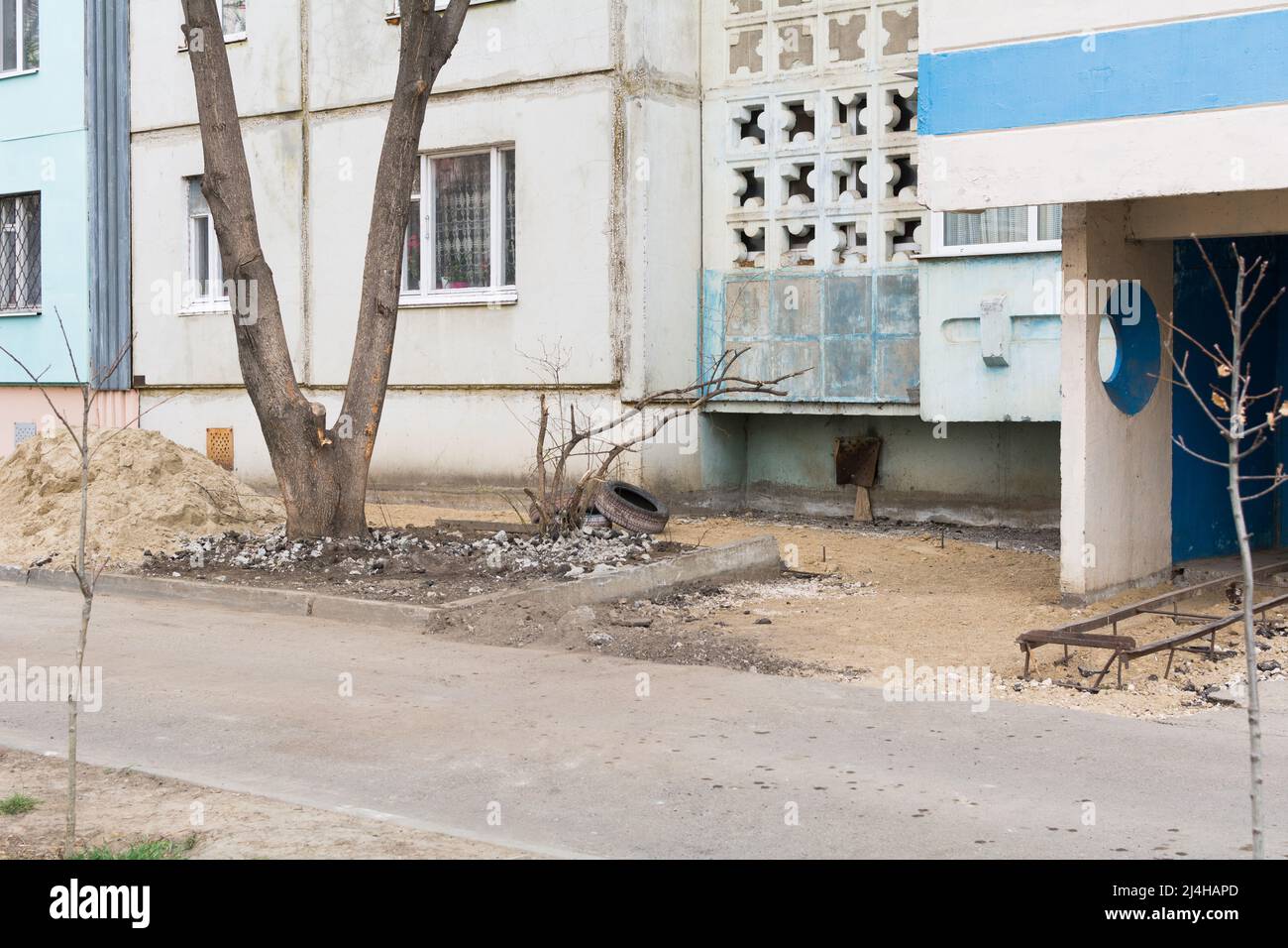 Sand and gravel at the base of a residential building. The process of ...
