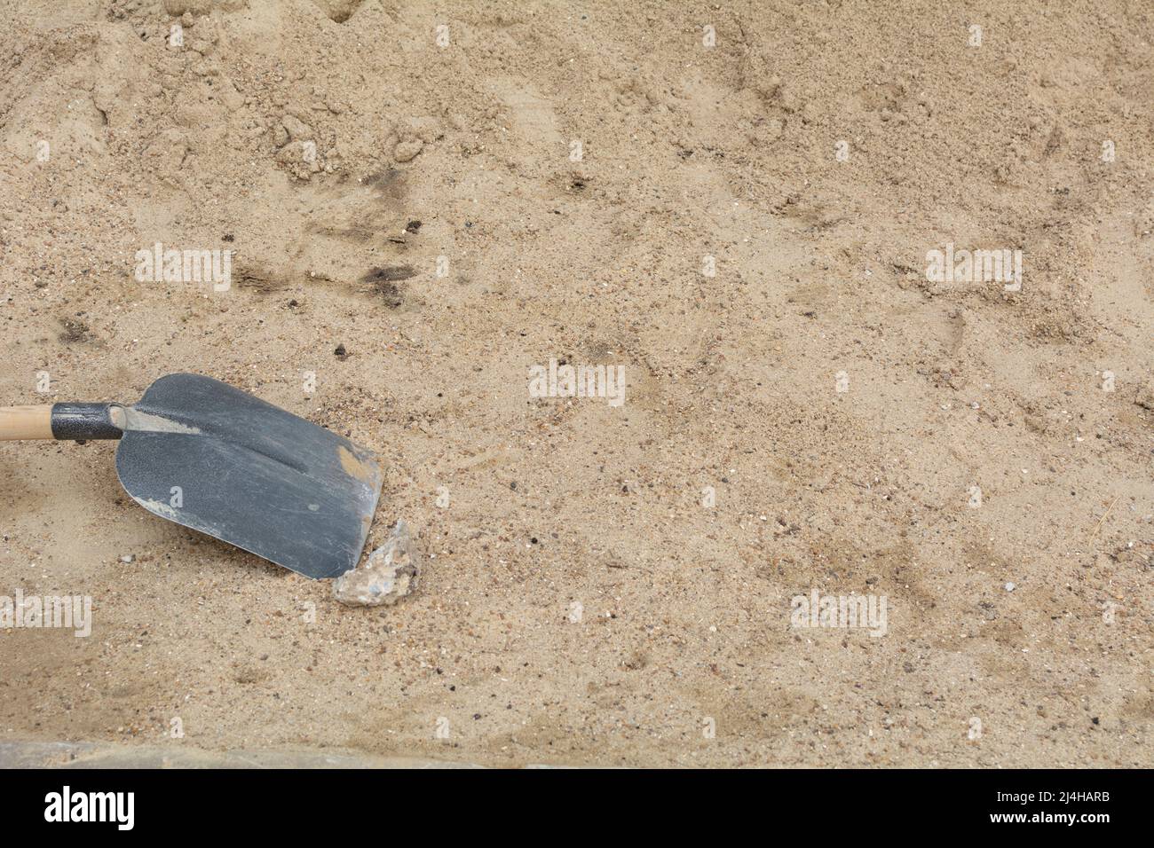 Shovel with wooden handle on the sand. Working tool in the environment ...