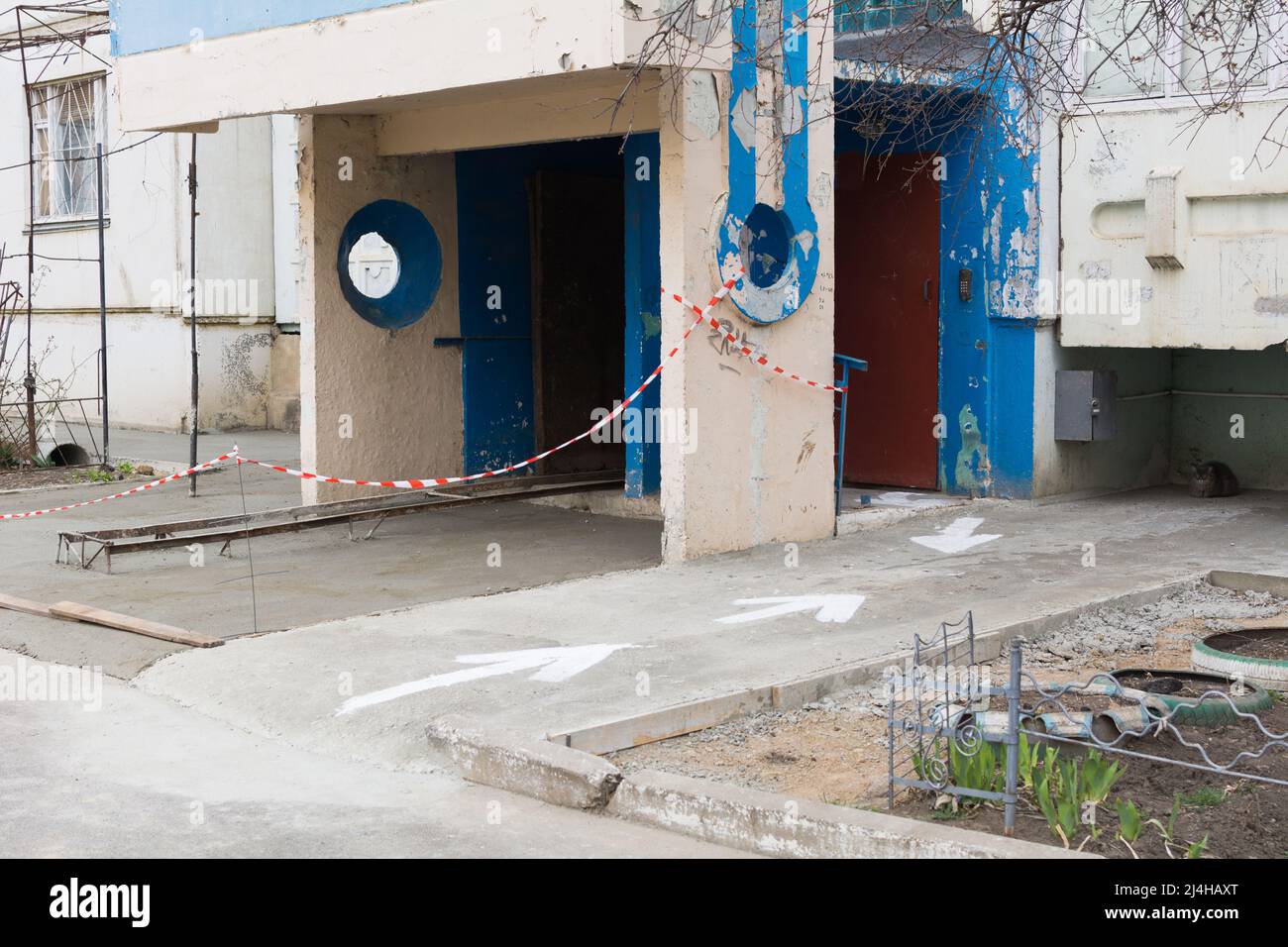 New concrete blind area apartment building. Blind area fenced with red ...