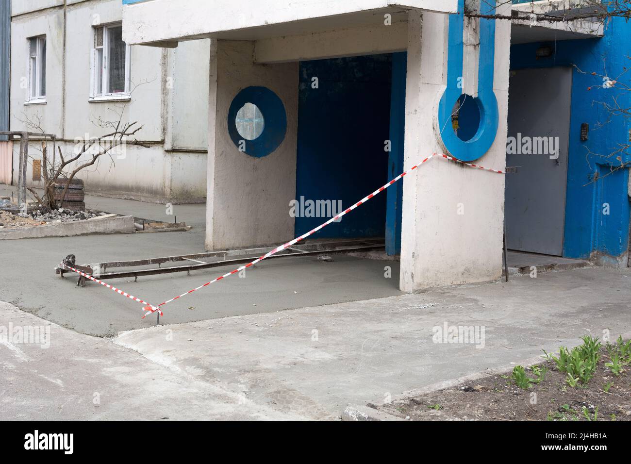 New concrete blind area apartment building. Blind area fenced with red ...