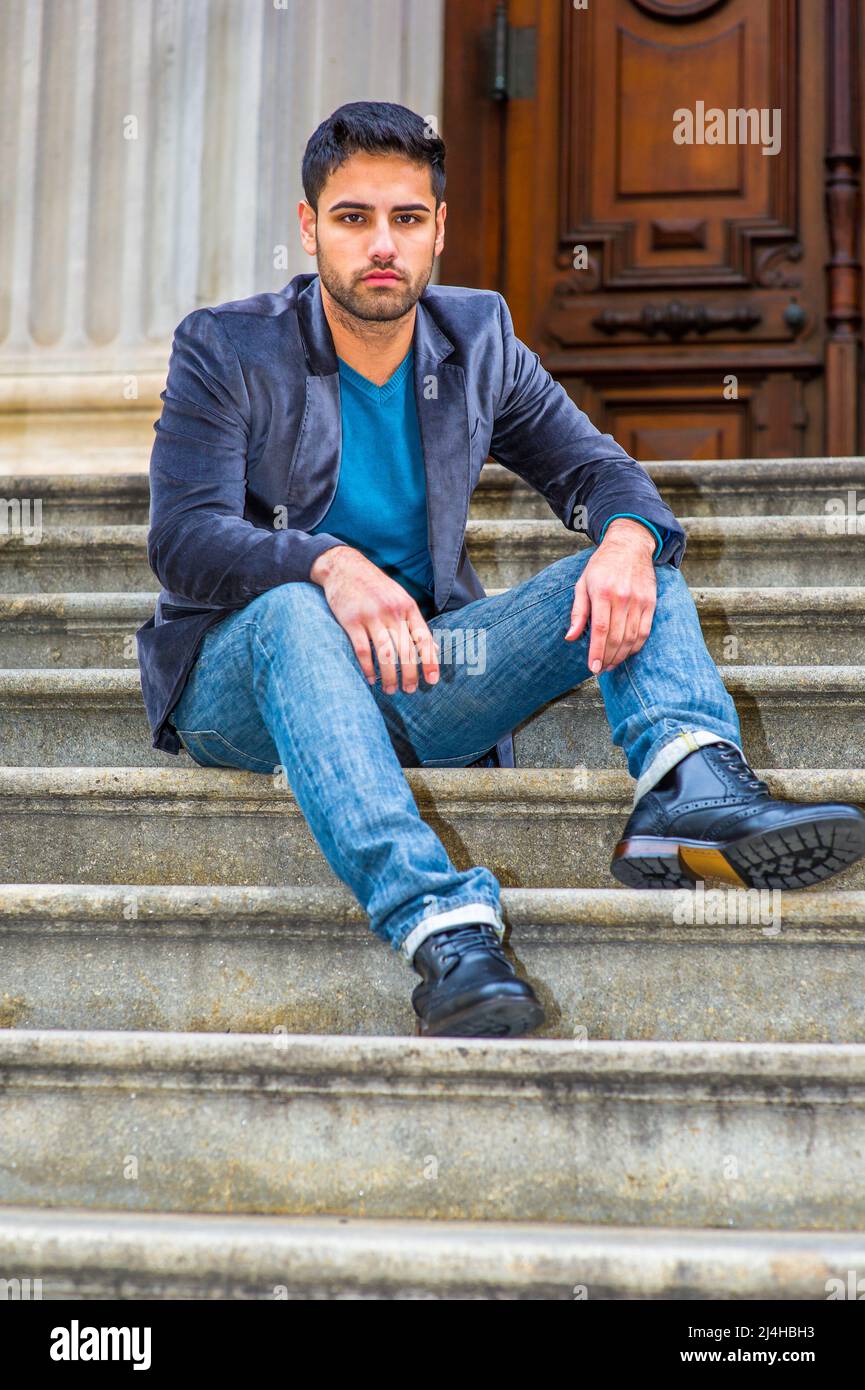 Dressing in a dark purple woolen blazer, blue jeans and black leather ...