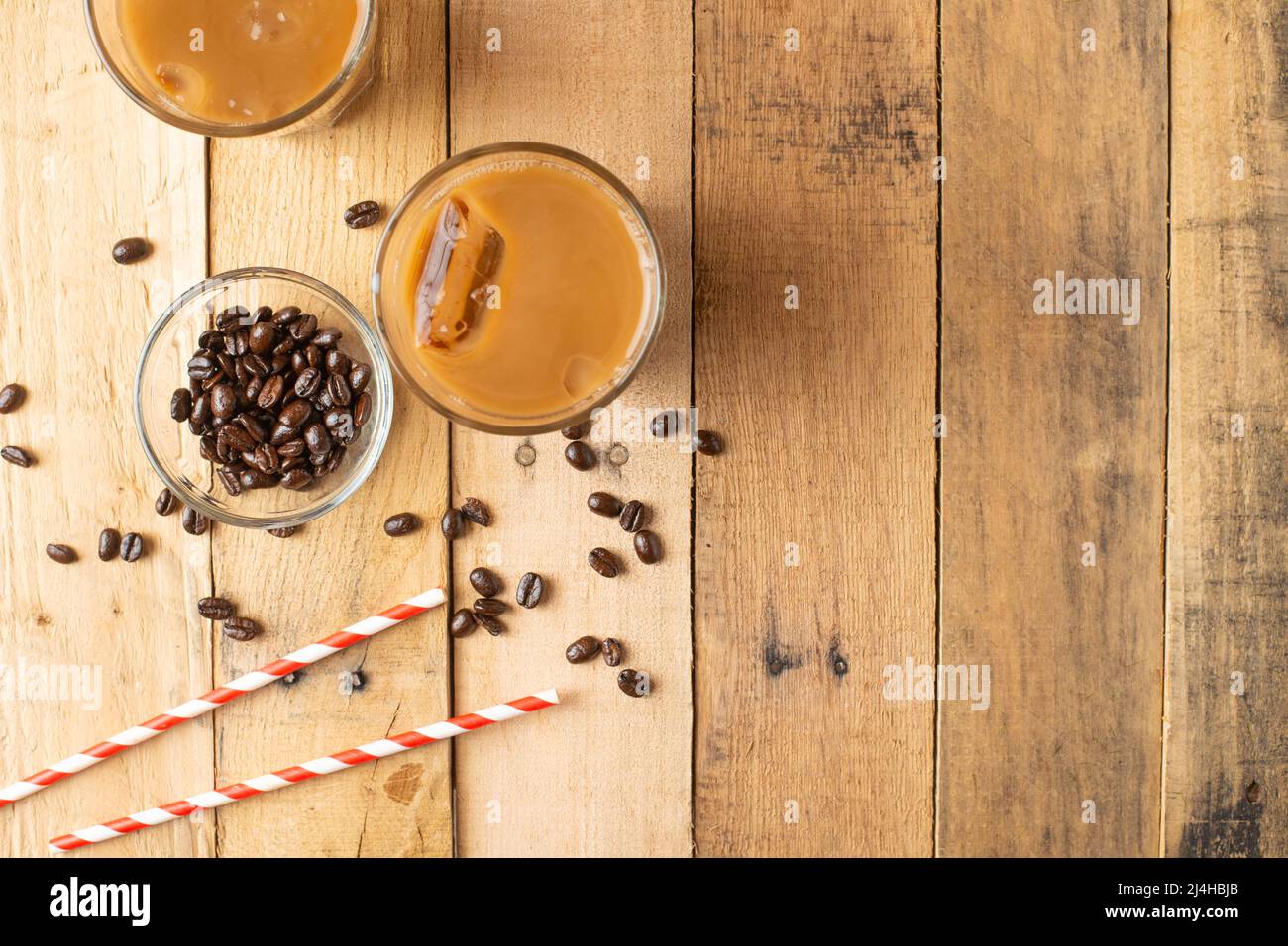 Flat lay. Cold coffee in transparent glasses with ice and straws, on a ...