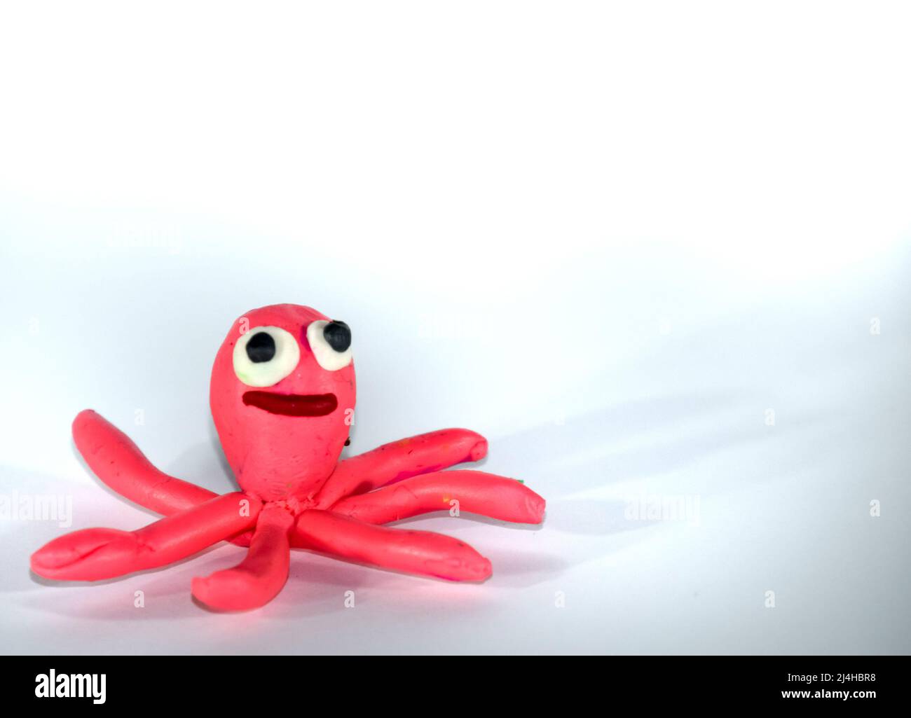 An octopus made of plasticine. Plasticine toys on a white background ...