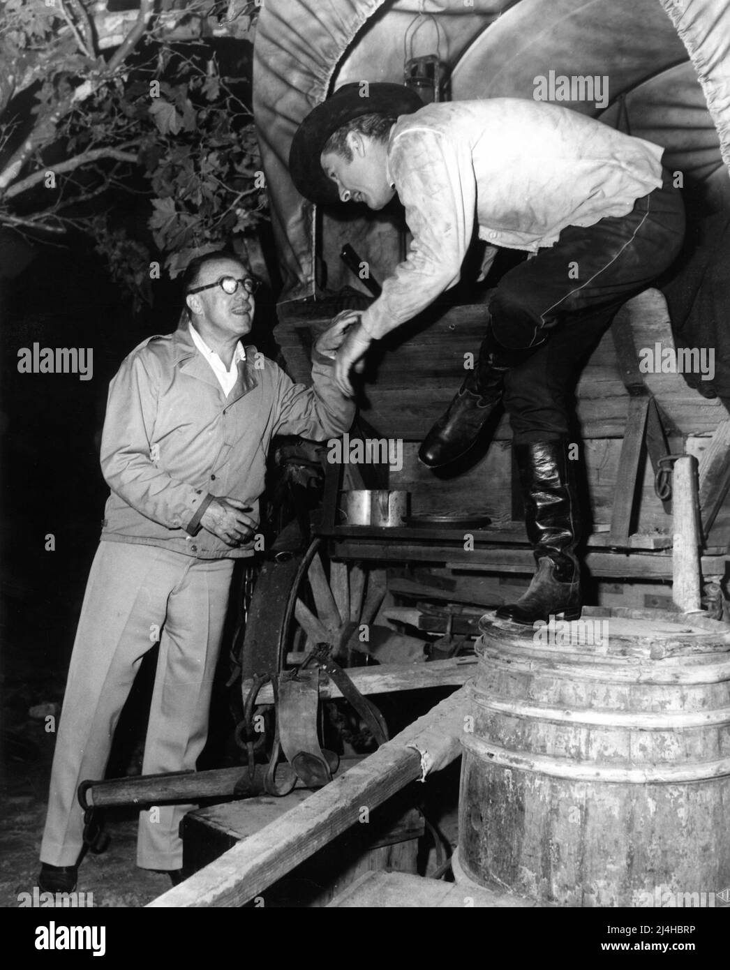 Director RAOUL WALSH and ERROL FLYNN on set candid during filming of ...