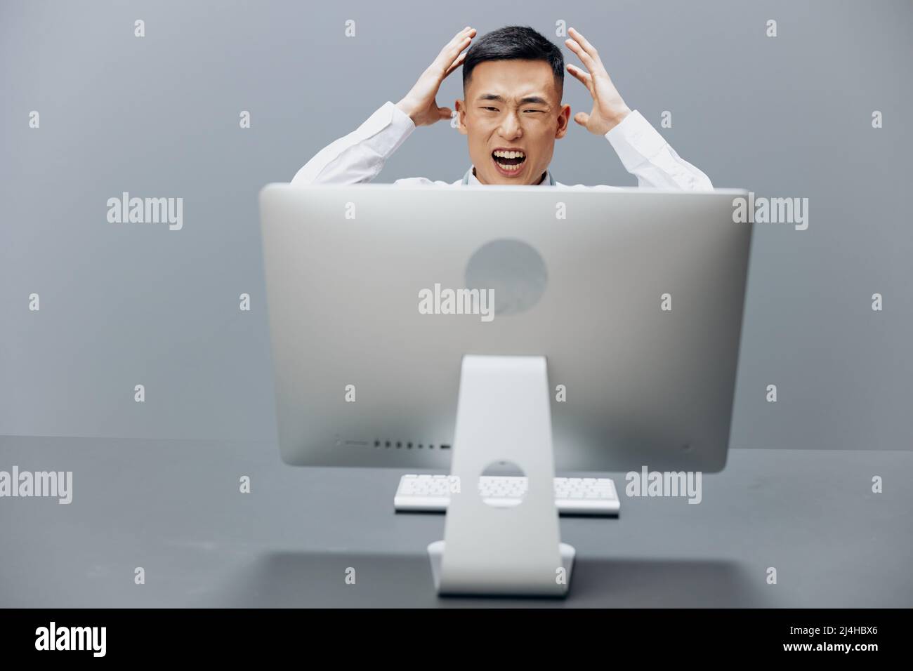 manager sits at a desk in front of a computer Internet Gray background ...