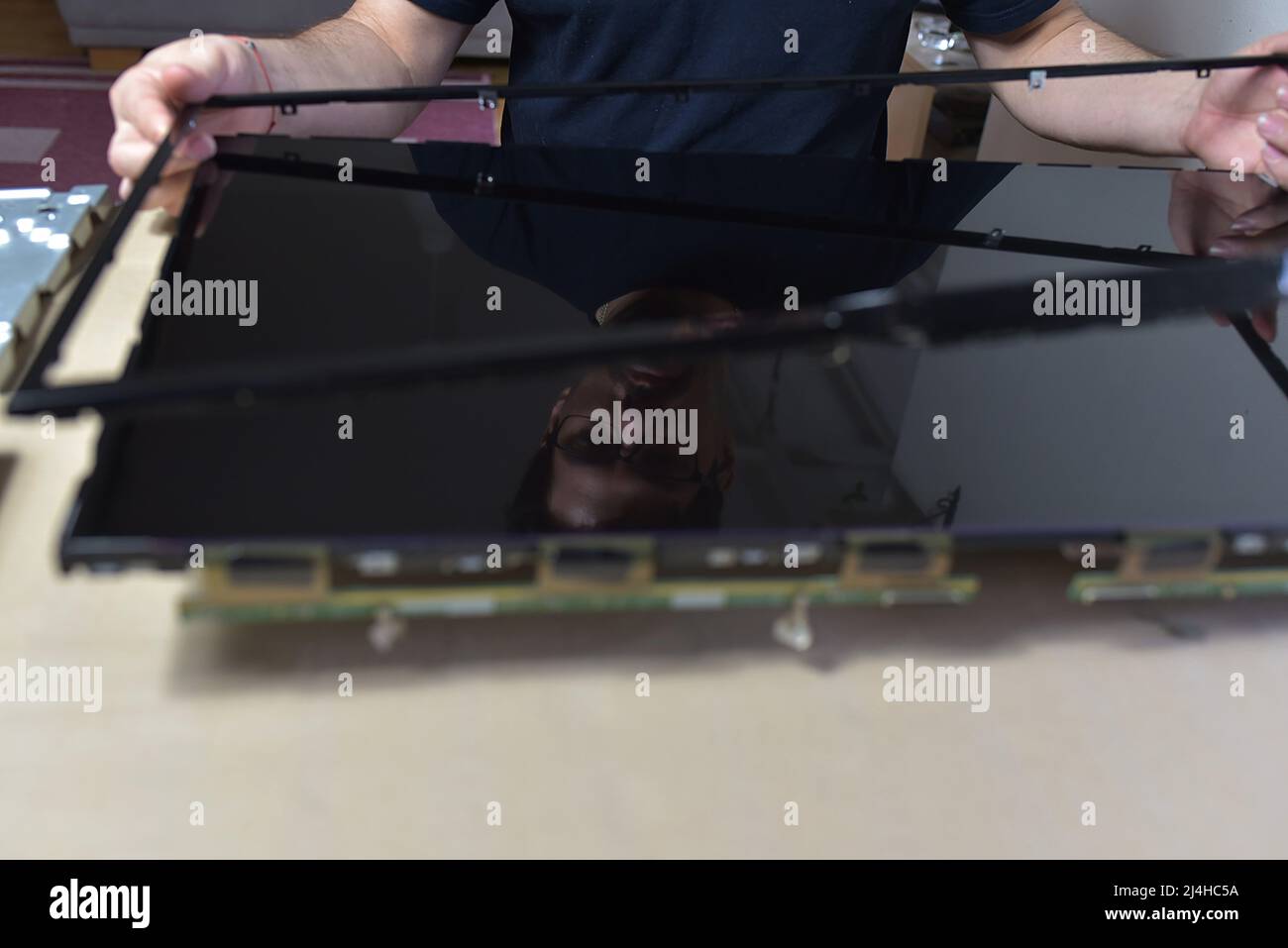 The man repairing broken tv Stock Photo - Alamy