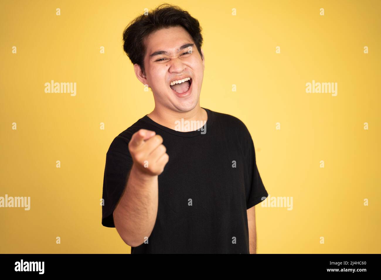 man opens mouth wide while laughing with fingers pointing Stock Photo ...