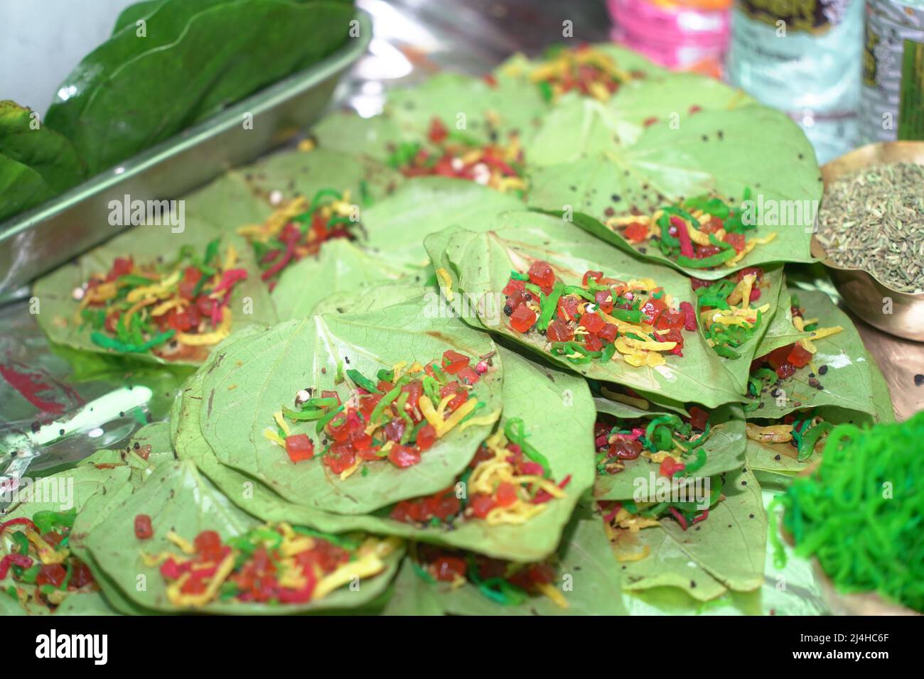 close up photo of a garnished banarasi pan, an indian mouth freshner ...