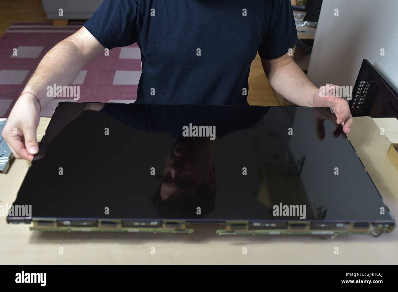 The man repairing broken tv Stock Photo - Alamy