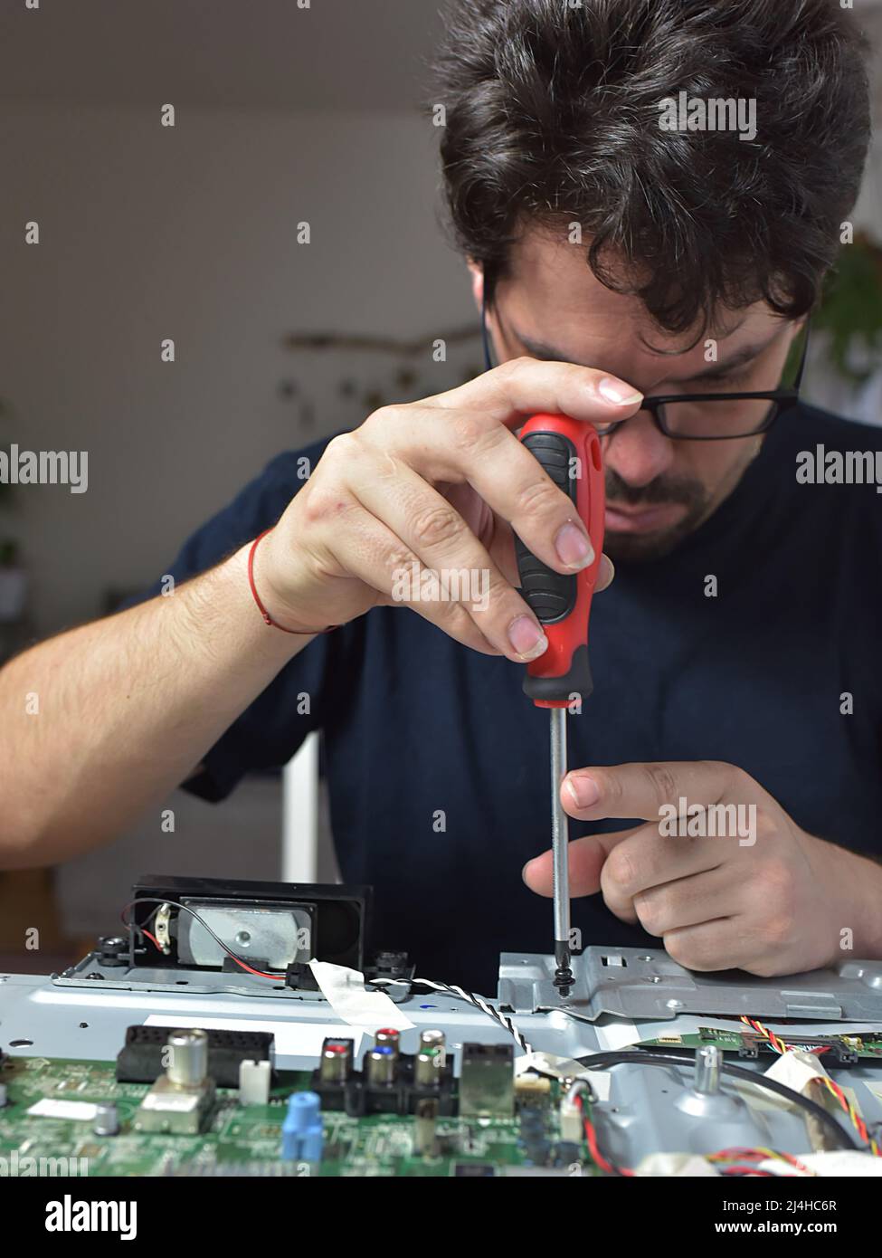 The man repairing broken tv Stock Photo - Alamy