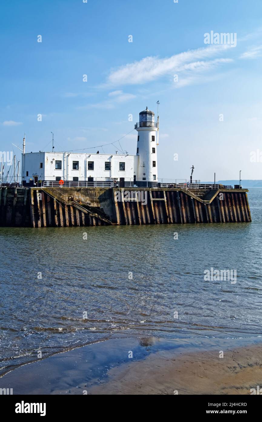 UK, North Yorkshire, Scarborough Lighthouse at the entrance to Harbour ...