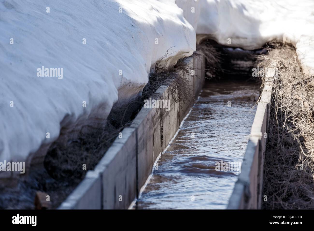 Concrete water drainage during spring flood in suburbs Stock Photo - Alamy