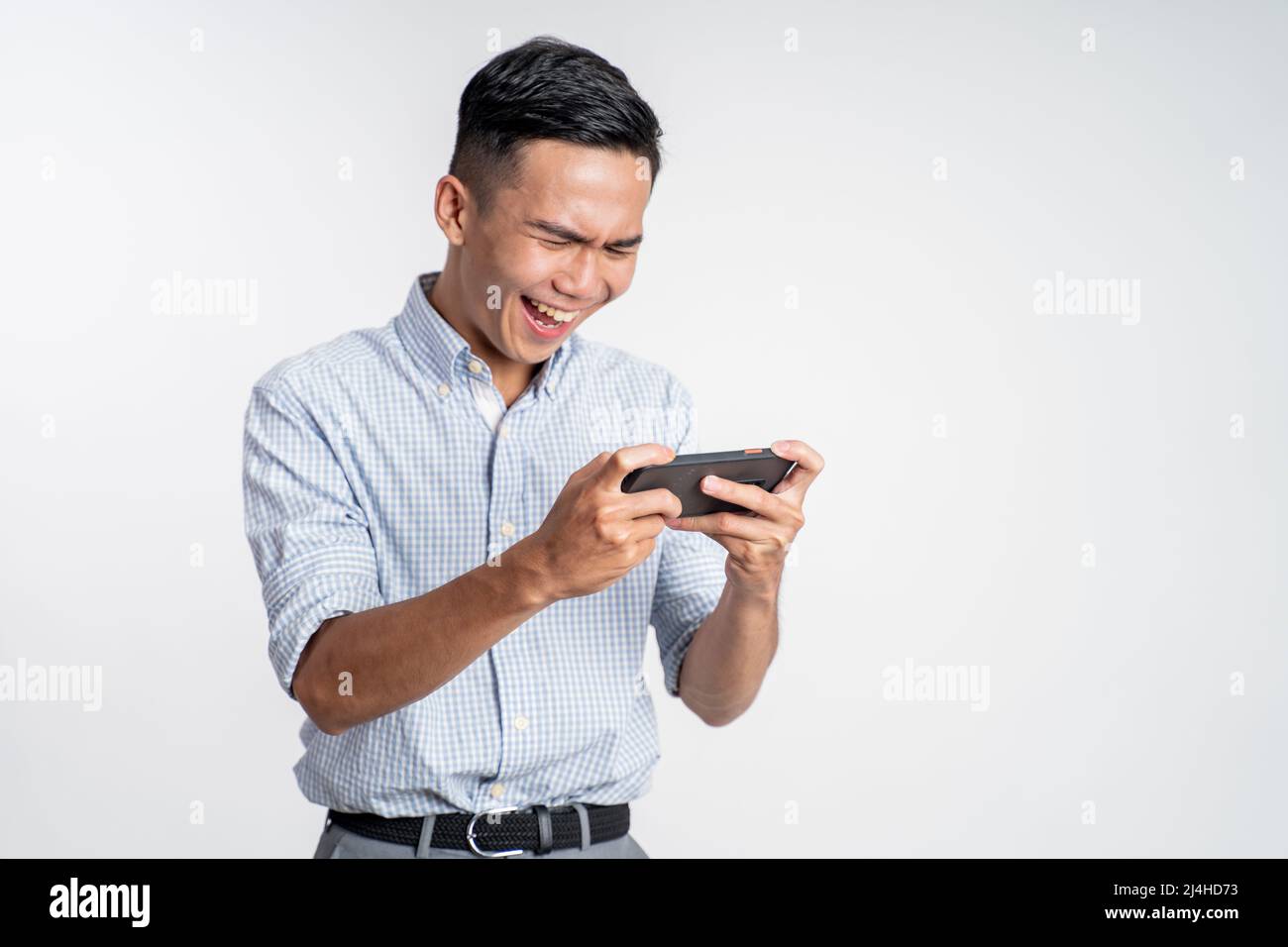 asian man playing video game on his smartphone Stock Photo - Alamy