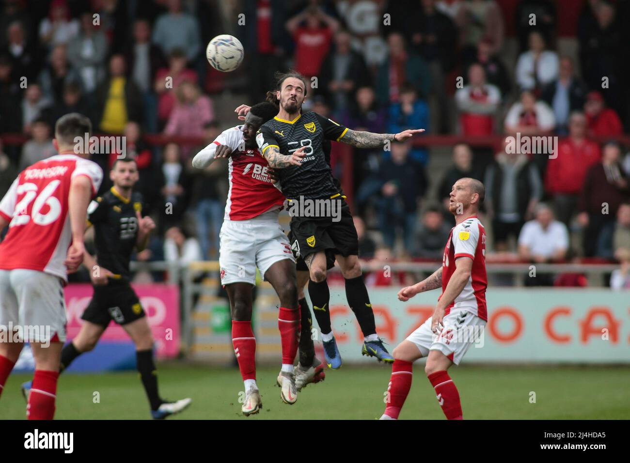 Fleetwood, UK. 15th Apr, 2022. Oxford's Ciaran Brown and Fleetwood's Toto Nsiala compete for the ...