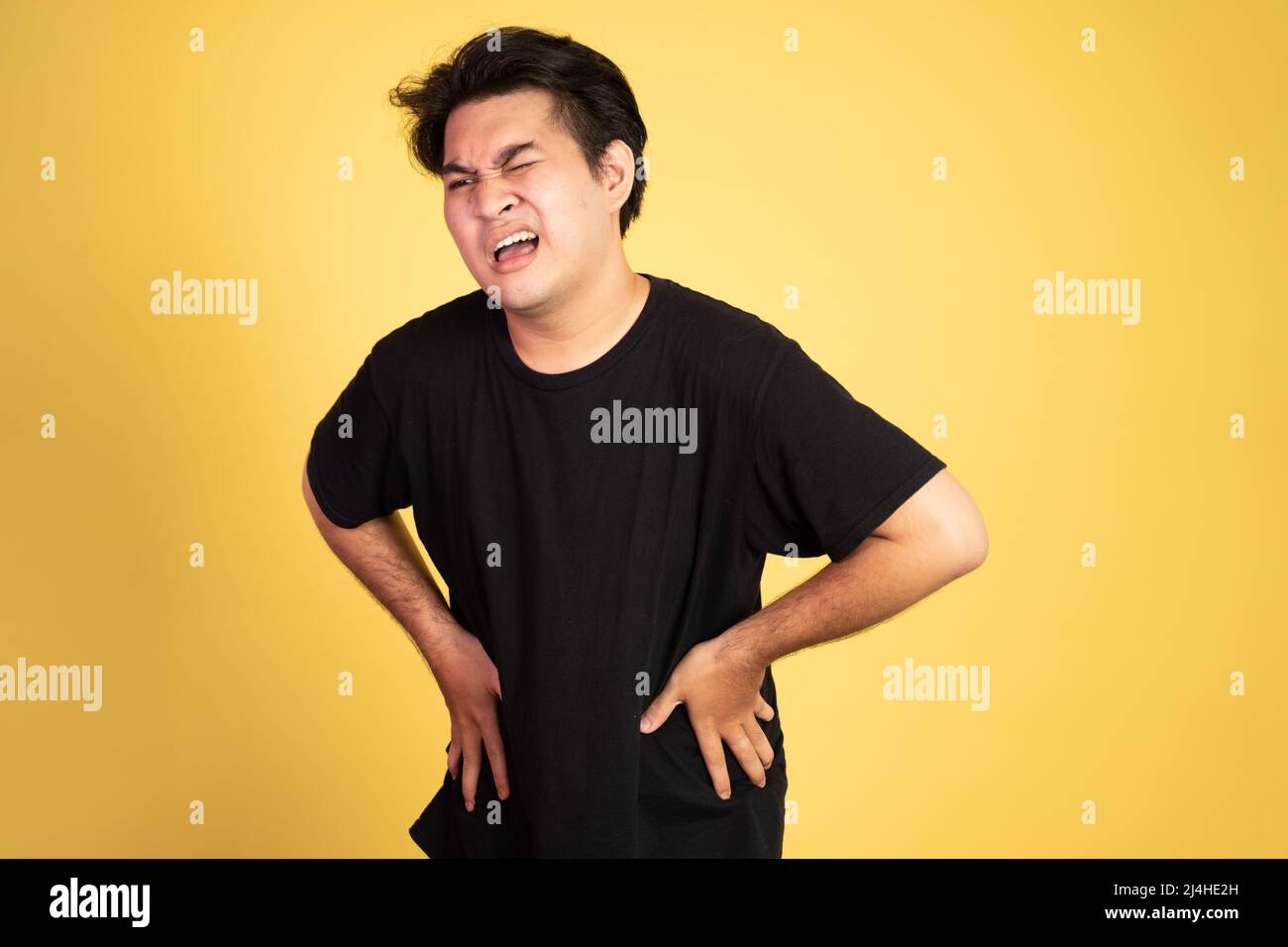 man having stomachache holding his stomach with two hands Stock Photo ...