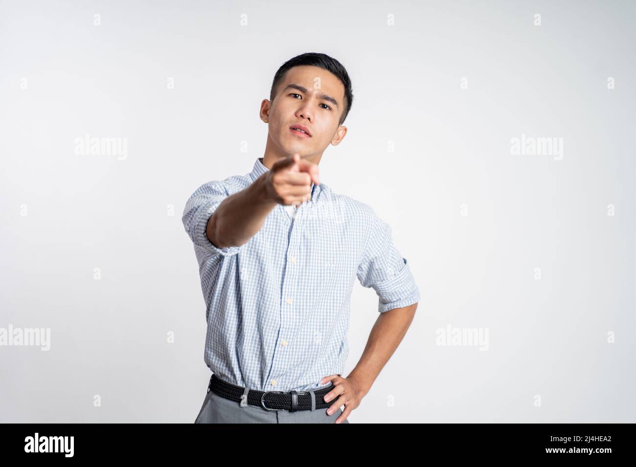 serious young businessman with finger pointing forward Stock Photo - Alamy