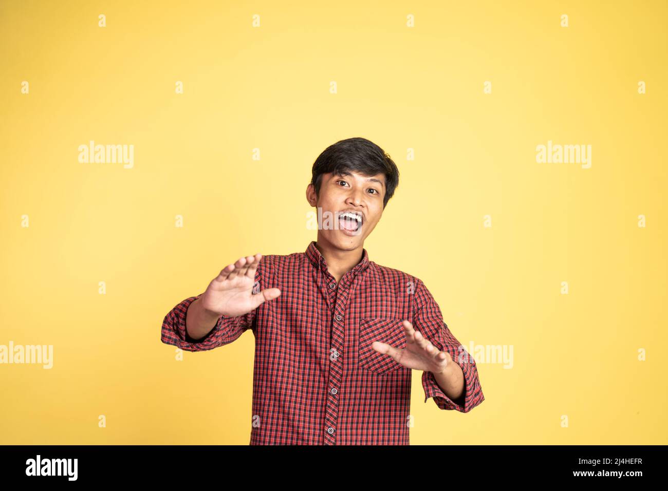 asian man shocked expression standing over isolated background Stock ...
