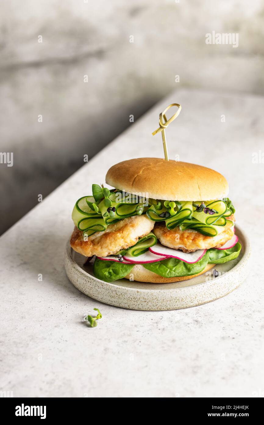 Homemade tasty burger with meat, spinach, cucumber, radish and ...