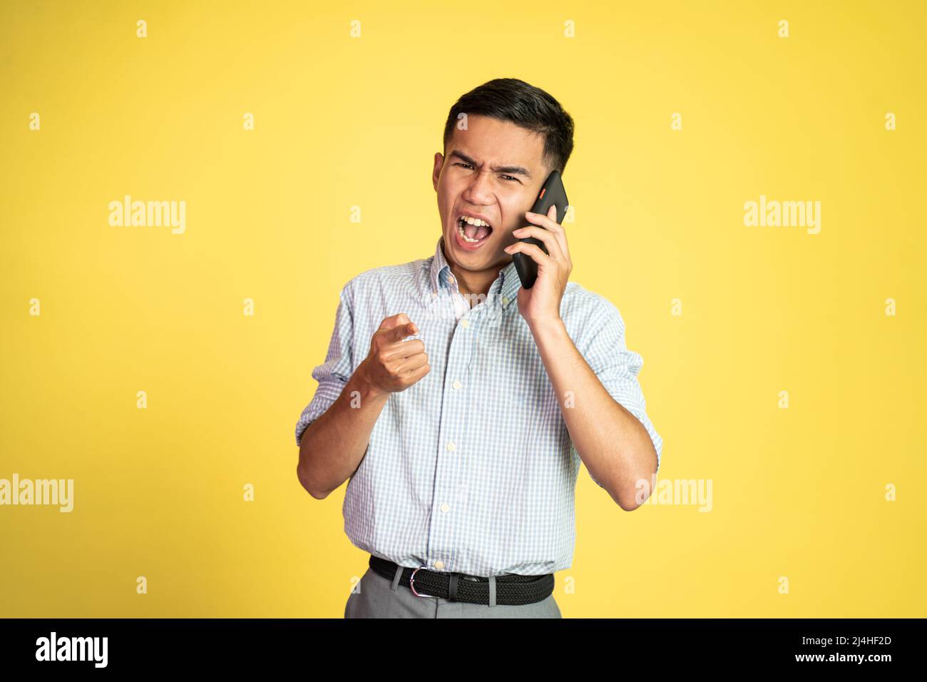 man shocked and angry while talking on his smartphone Stock Photo - Alamy