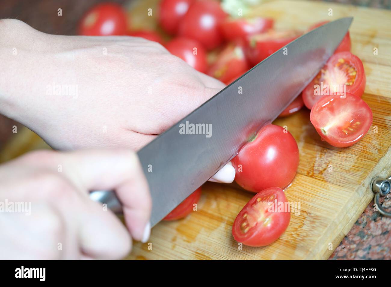 Chef is cutting tomatoes in kitchen and vegetarianism Stock Photo - Alamy