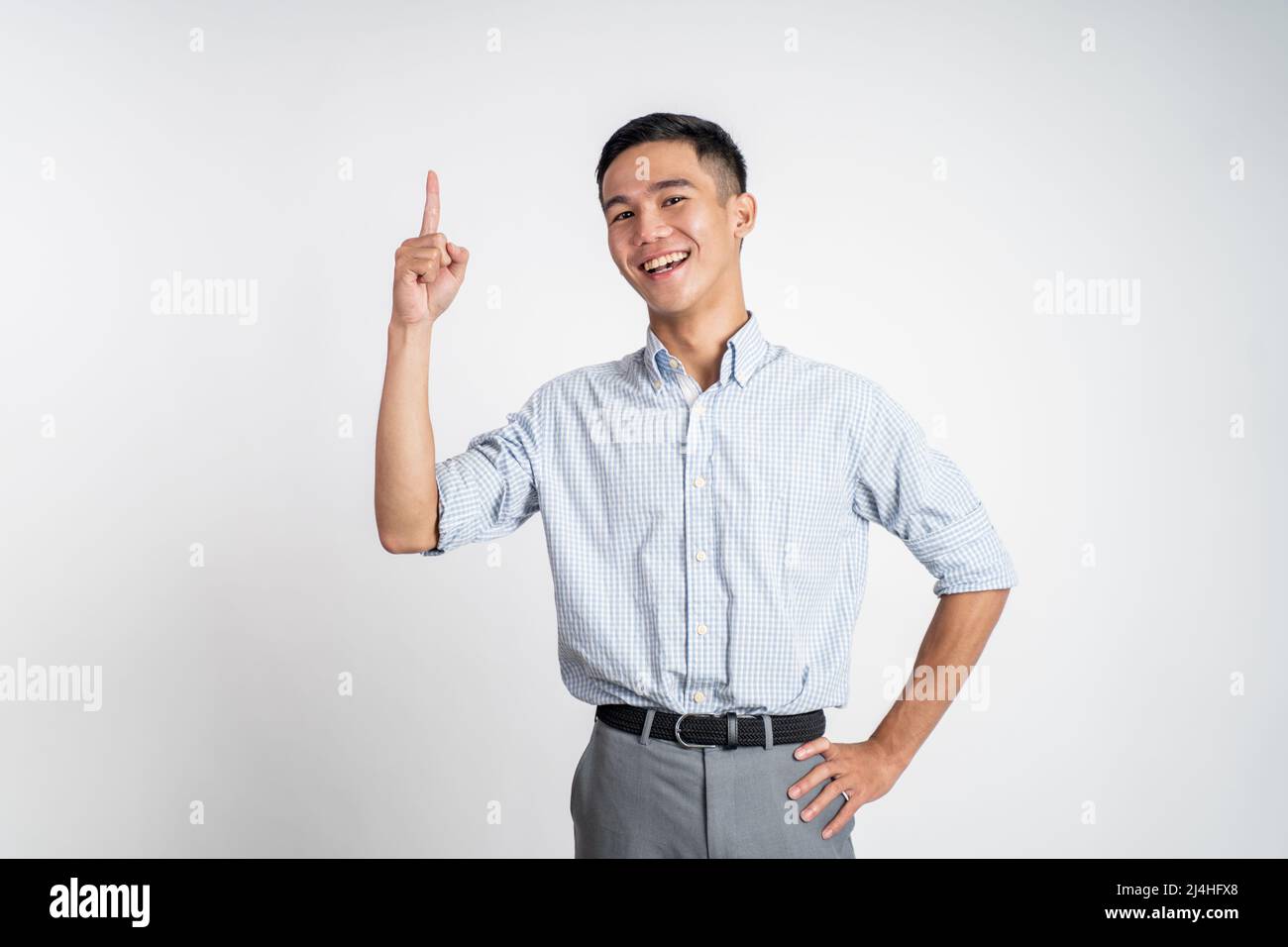 excited young man with fingers pointing up Stock Photo - Alamy