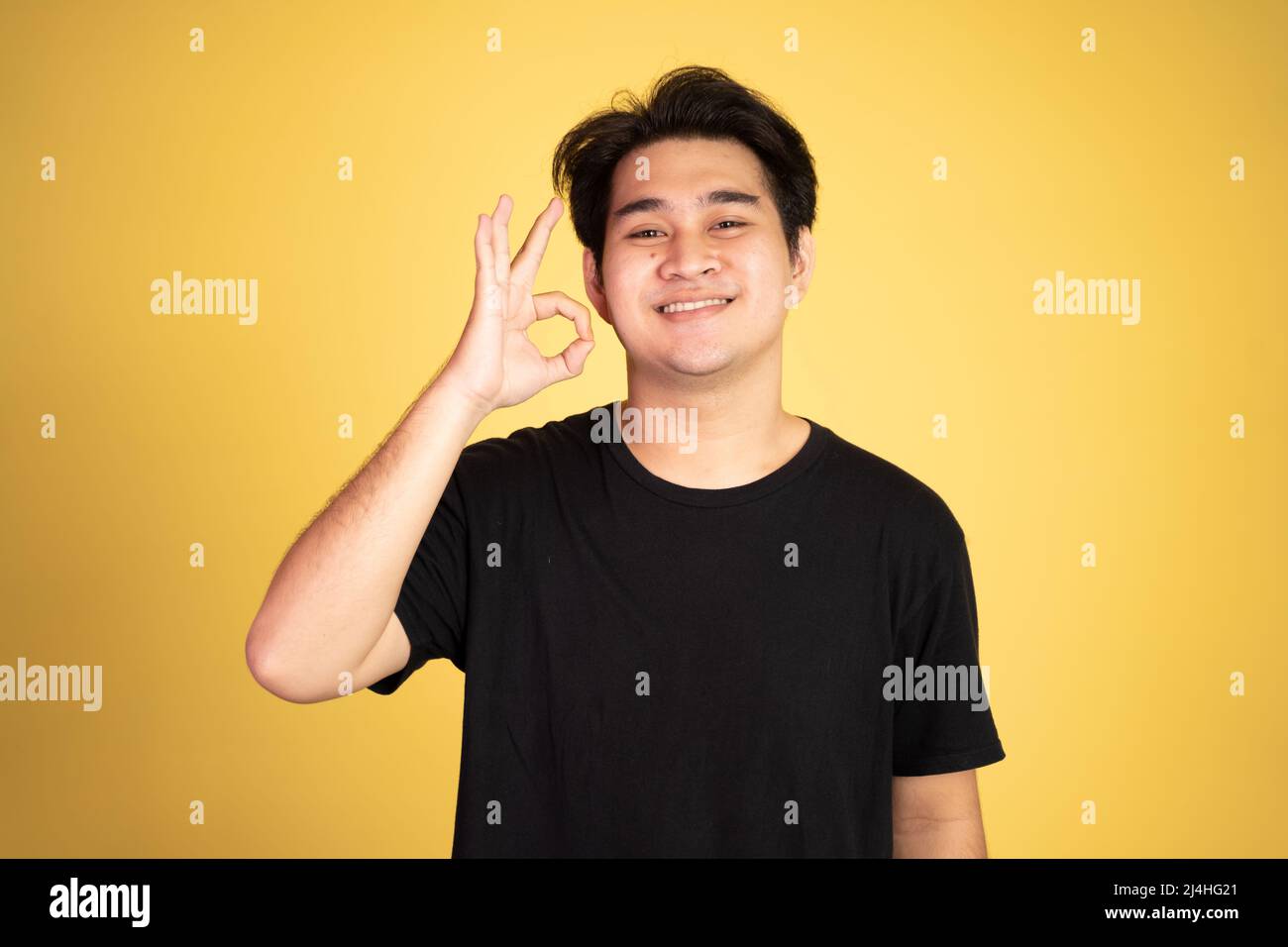 asian young man showing okay hand gesture with smiling Stock Photo - Alamy