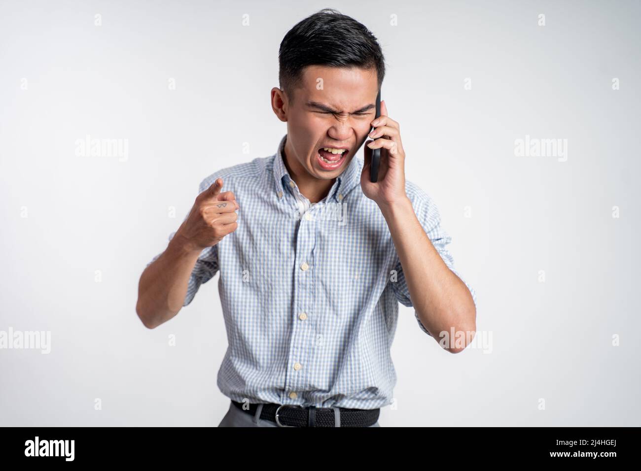 man shocked and angry while talking on his smartphone Stock Photo - Alamy