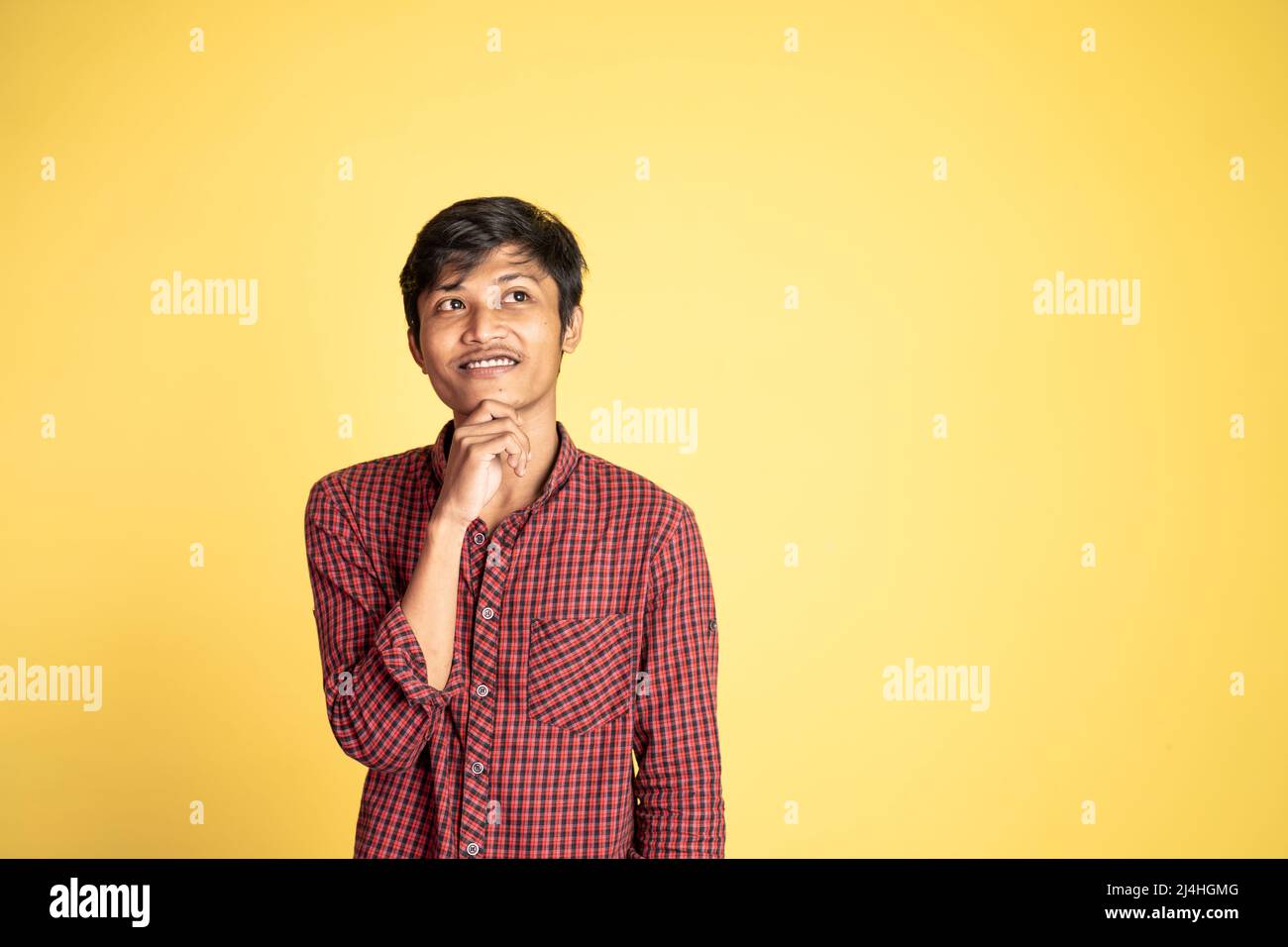 asian man thinking something and looking up Stock Photo - Alamy