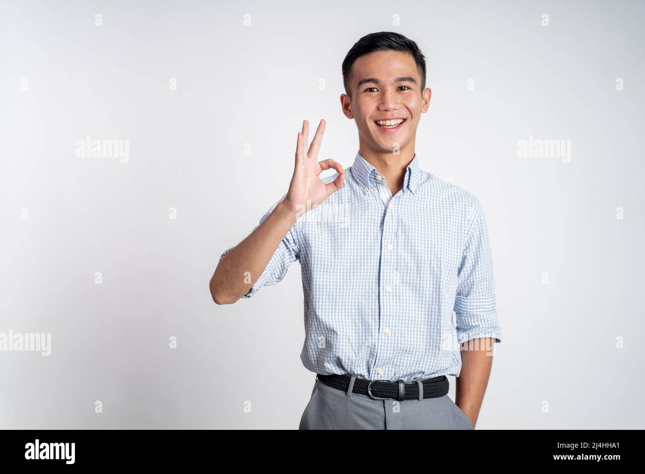 asian young man showing okay hand gesture with smiling Stock Photo - Alamy
