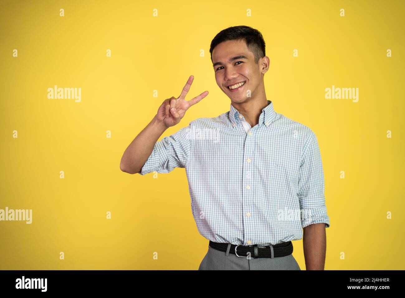 asian man with cute hand gesture making v shape on finger Stock Photo ...