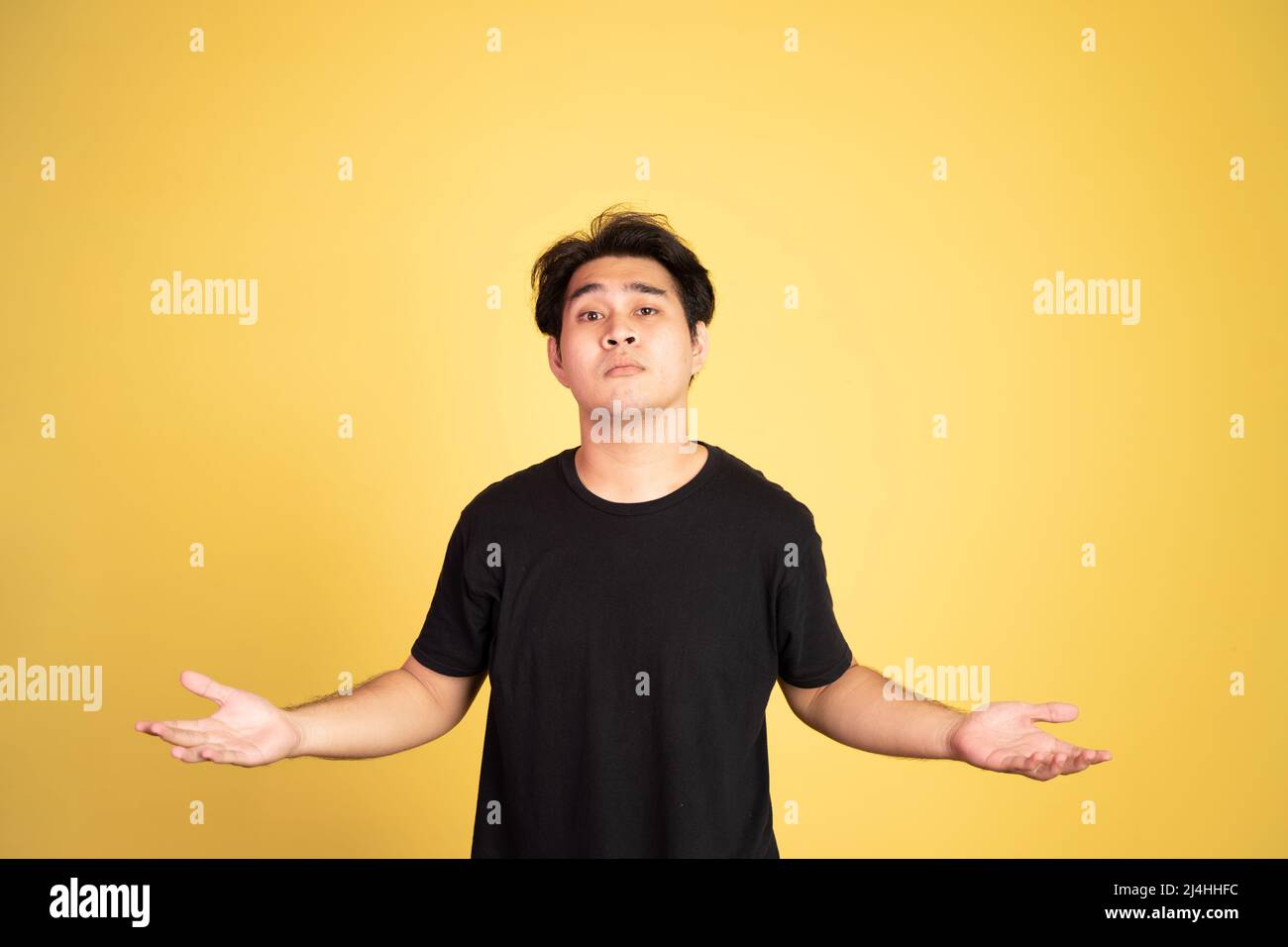 man with both hands looking up with a questioning expression Stock ...