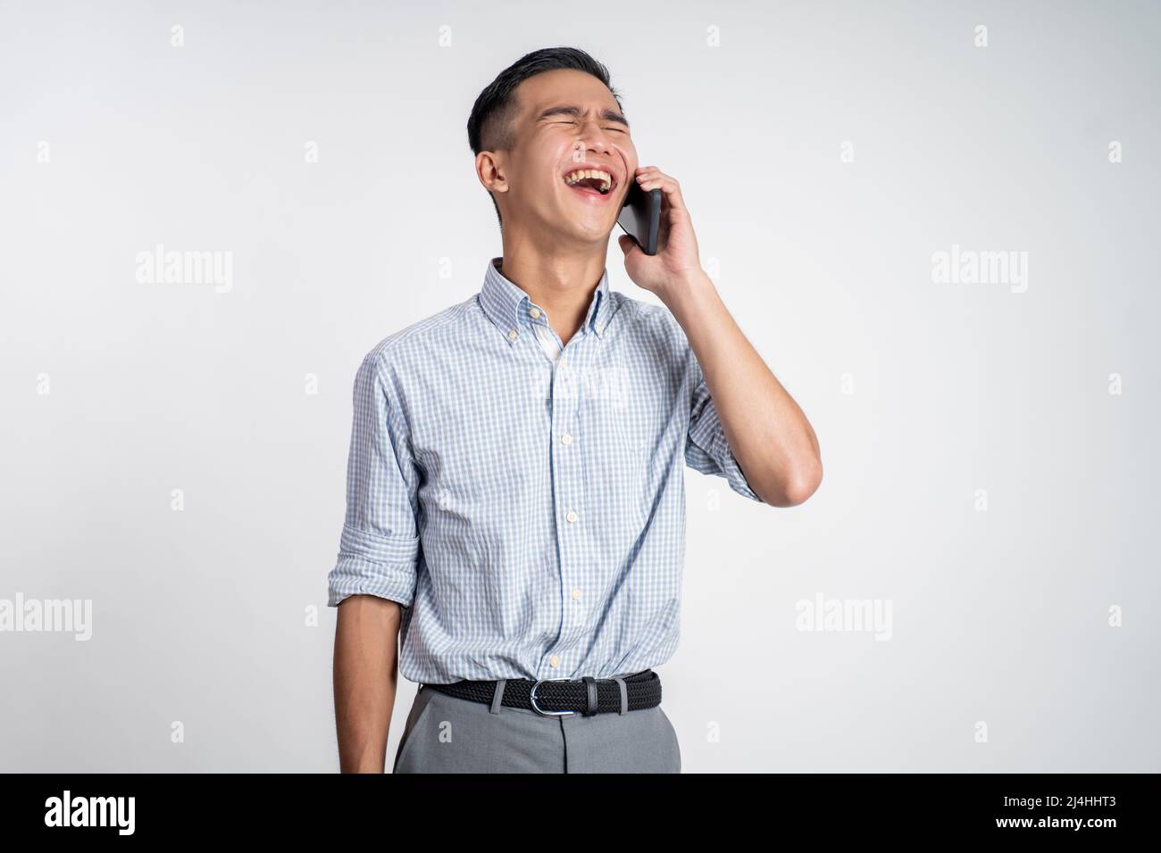 business worker laughing while talking on a phone Stock Photo - Alamy
