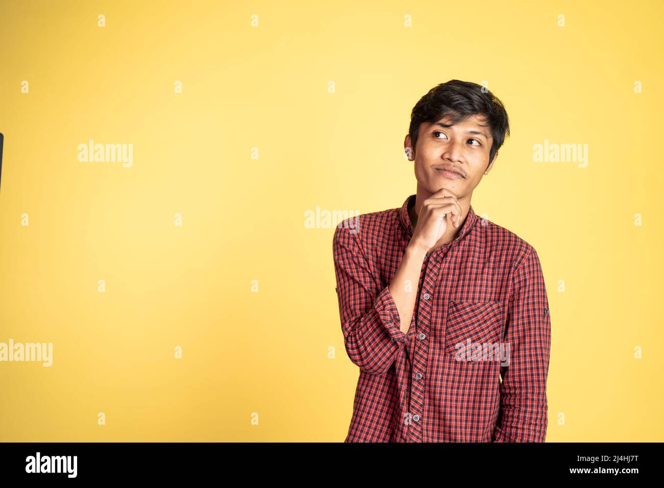asian man thinking something and looking up Stock Photo - Alamy
