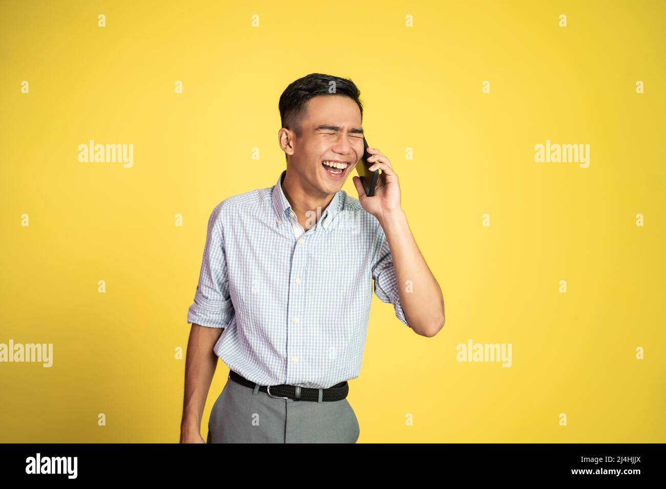 business worker laughing while talking on a phone Stock Photo - Alamy