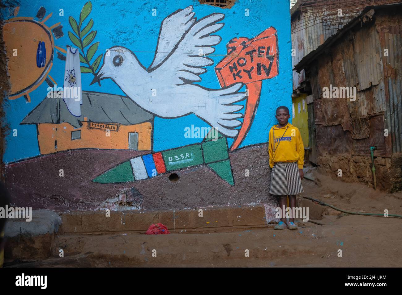 Nairobi, Kenya. 14th Apr, 2022. A girl poses by a street mural created ...