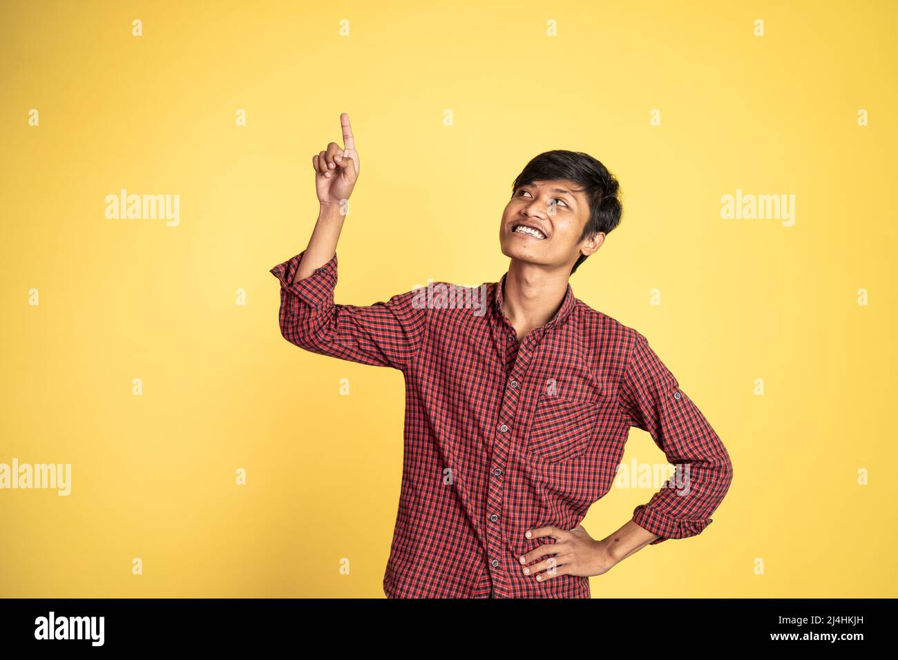 excited young man with fingers pointing up Stock Photo - Alamy