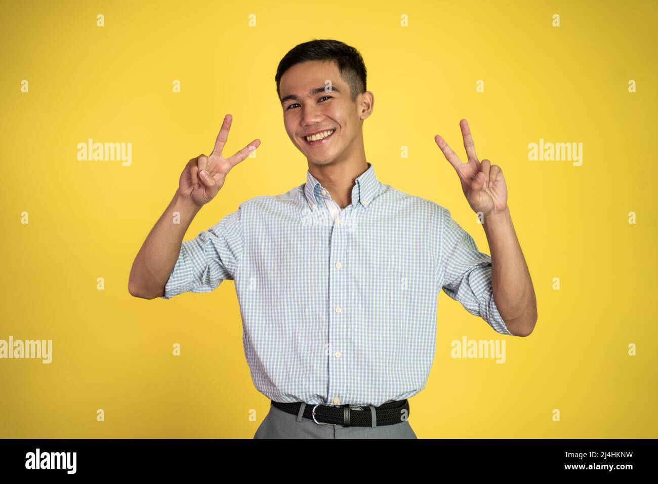 asian man with cute hand gesture making v shape on finger Stock Photo ...