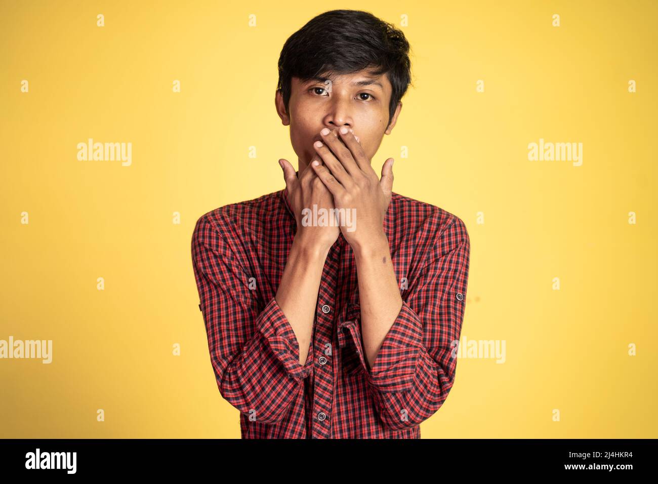 portrait of a man with hands covering mouth Stock Photo - Alamy