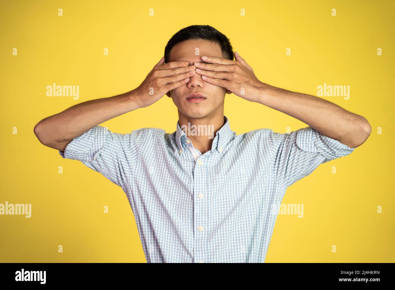 Scared man covering eyes hi-res stock photography and images - Alamy
