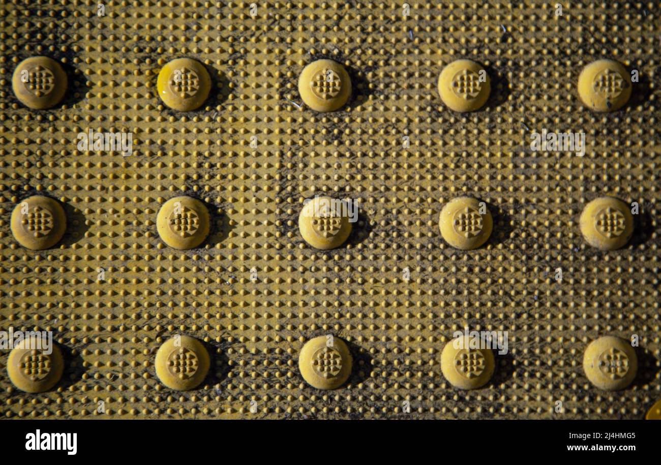 yellow pavement studs shot close up in landscape format for use as a ...