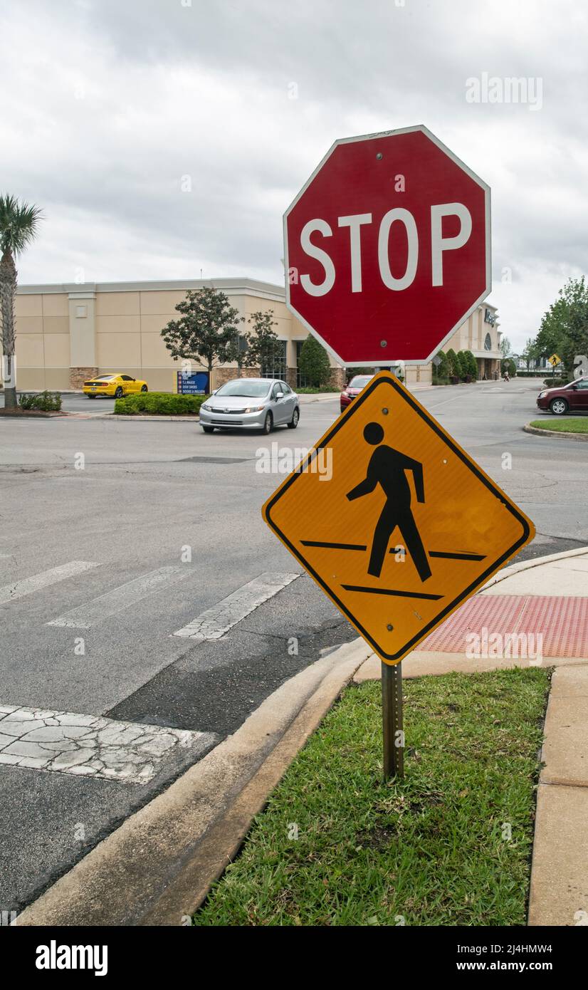 Kissimmee, Florida, USA, two traffic signs, (Stop and Ped Xing) share a ...