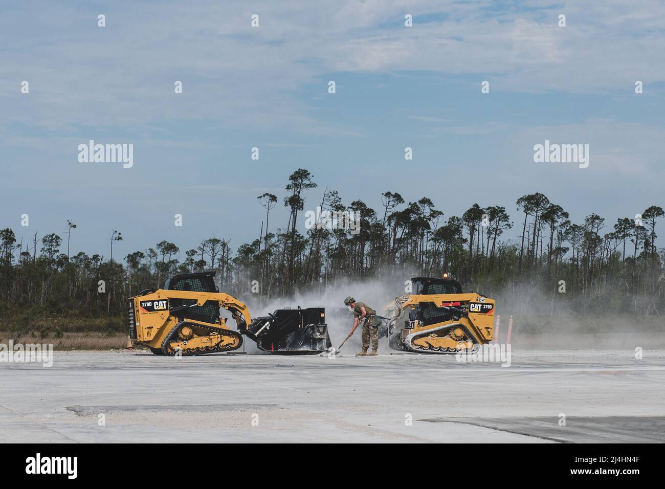 U.S. Air Force Airmen use compact track loaders attached with skid ...