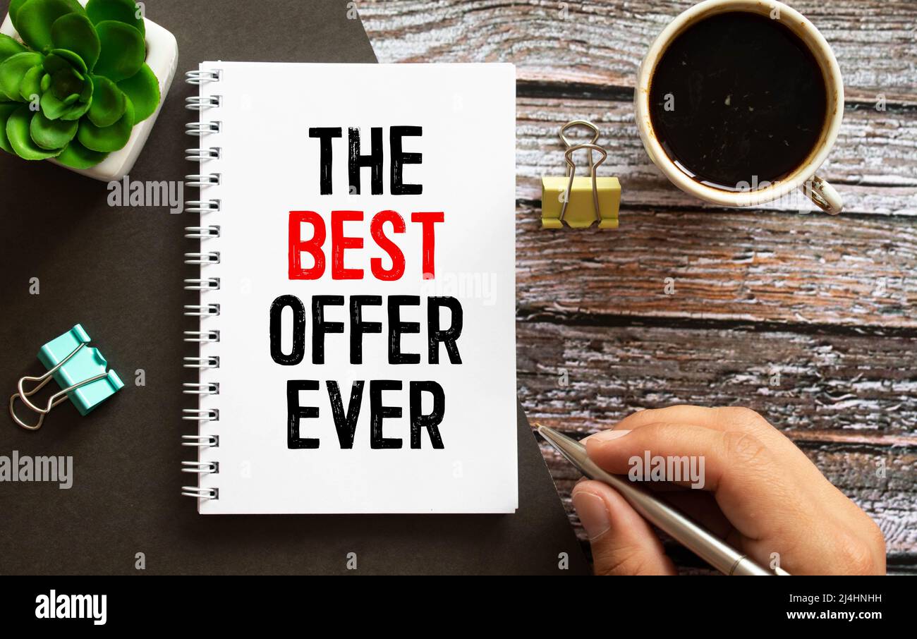 BEST OFFER text on the notepad with paper sheet with pen and wooden ...