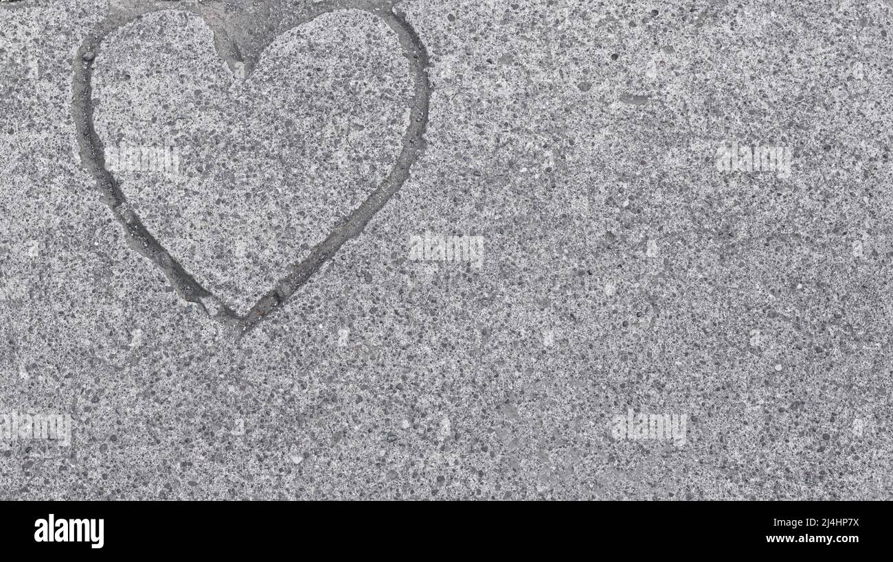 Free formed heart shape in concrete pavement. Copy space for text ...