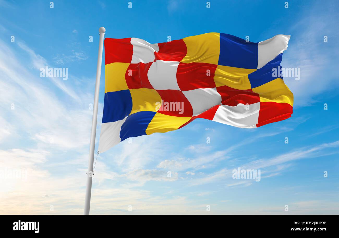 official flag of Antwerp, Belgium at cloudy sky background on sunset ...